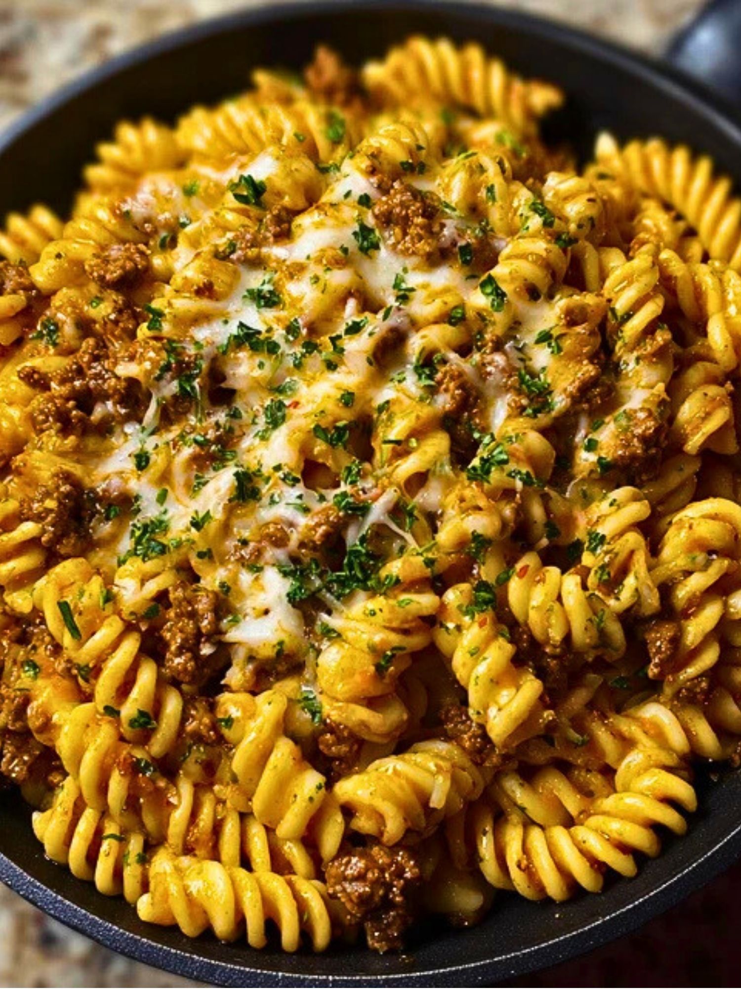 Cheesy Garlic Twisted Pasta with Cajun Ground Beef and Alfredo Velveeta